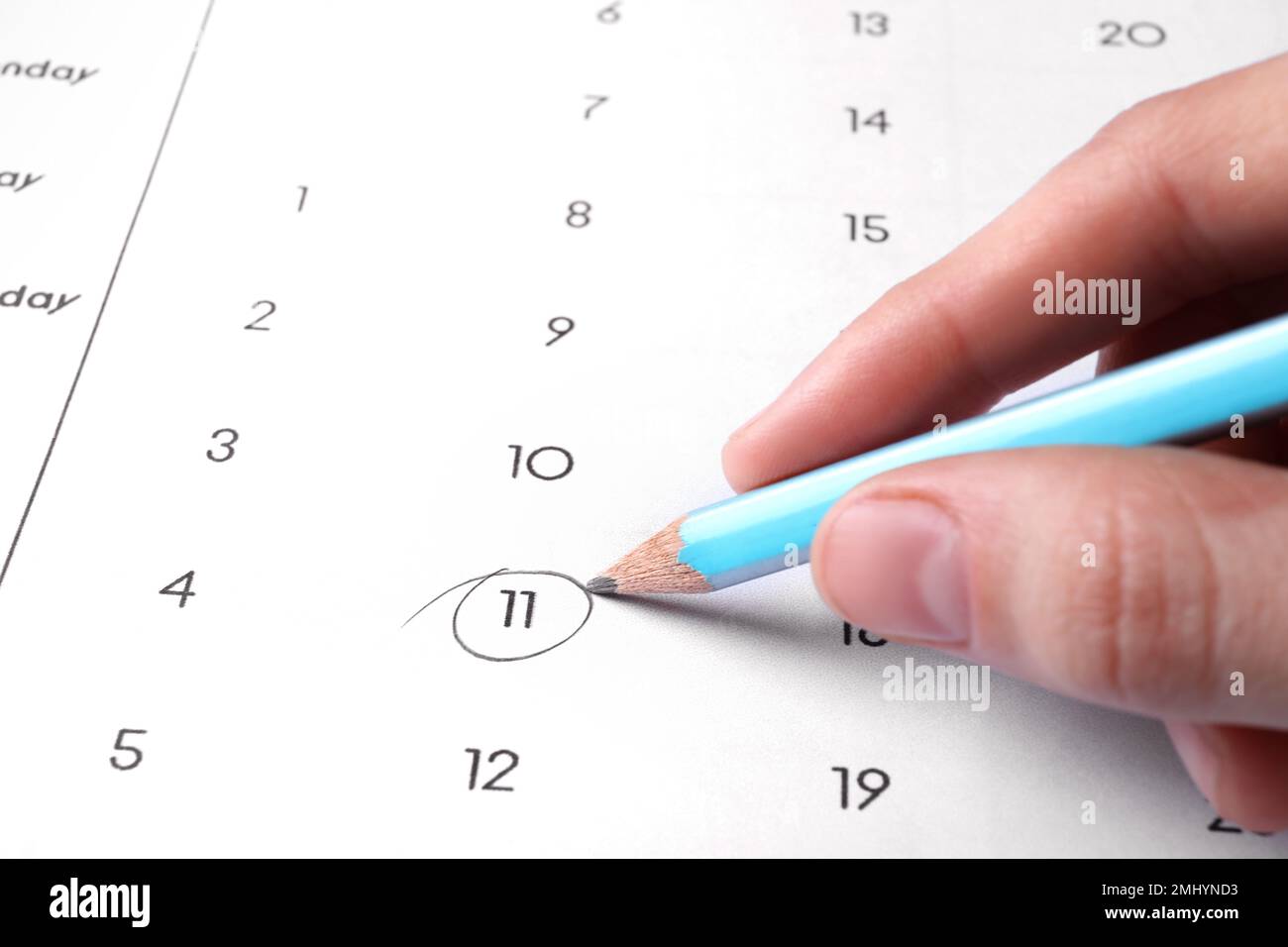 Woman marking date in calendar with pencil, closeup Stock Photo - Alamy