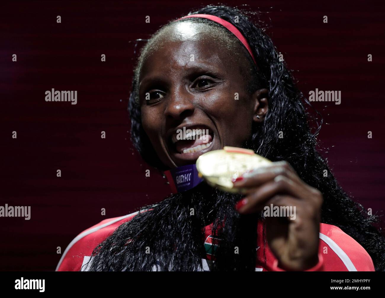Hellen Obiri of Kenya shows her gold medal, during the medal ceremony ...