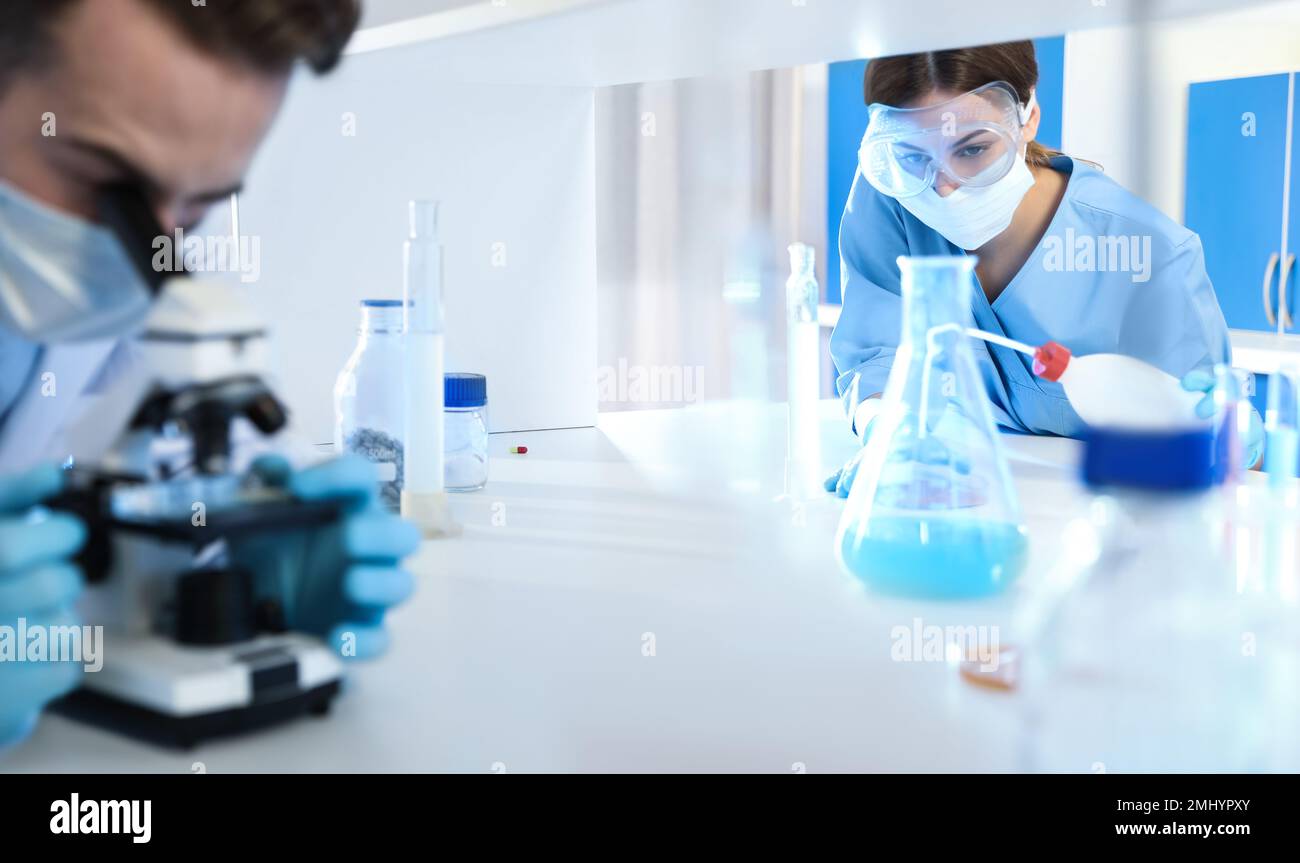 Young scientists doing research and analysis in chemical laboratory ...