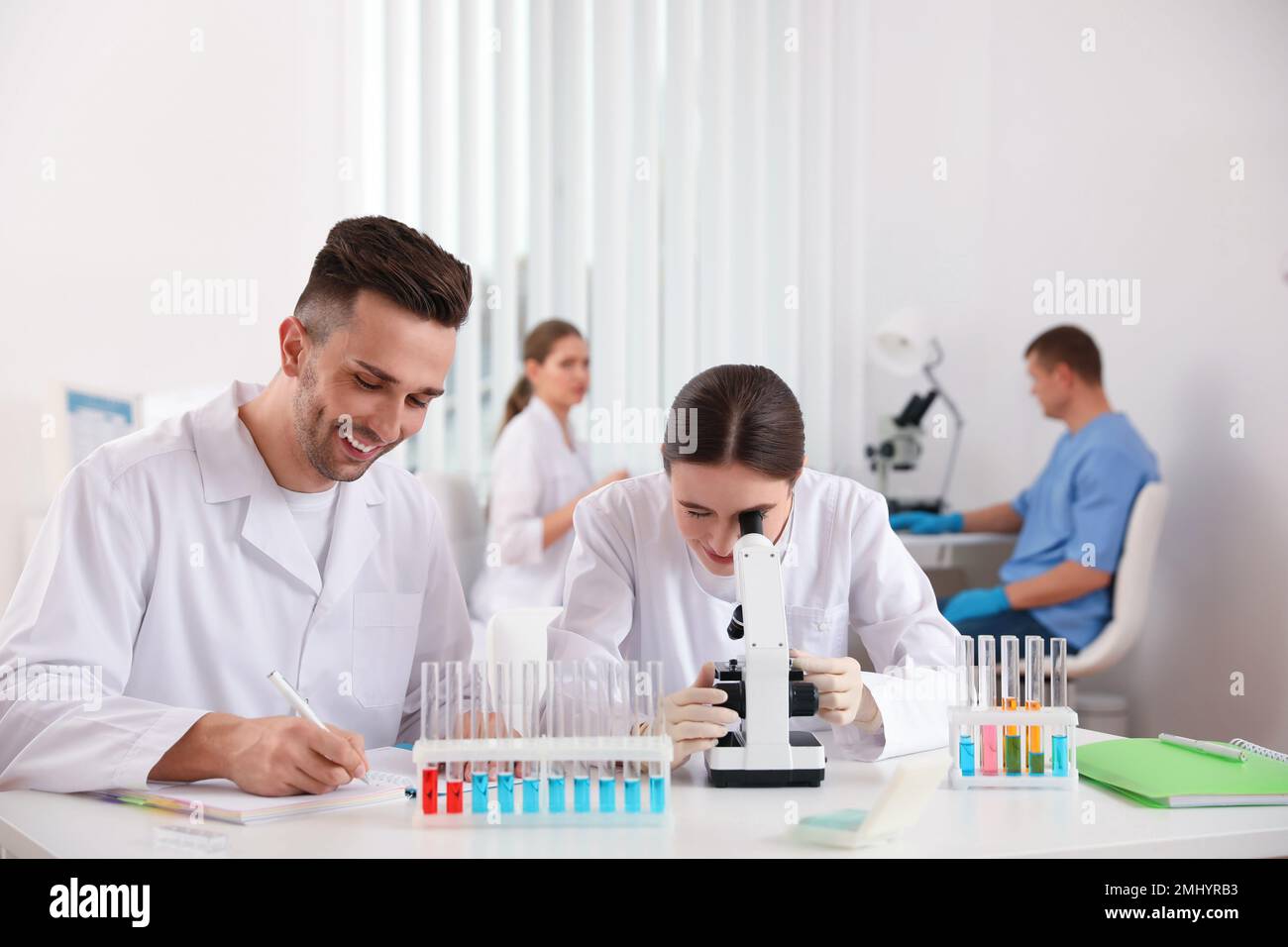 Medical students with microscope in modern laboratory Stock Photo - Alamy