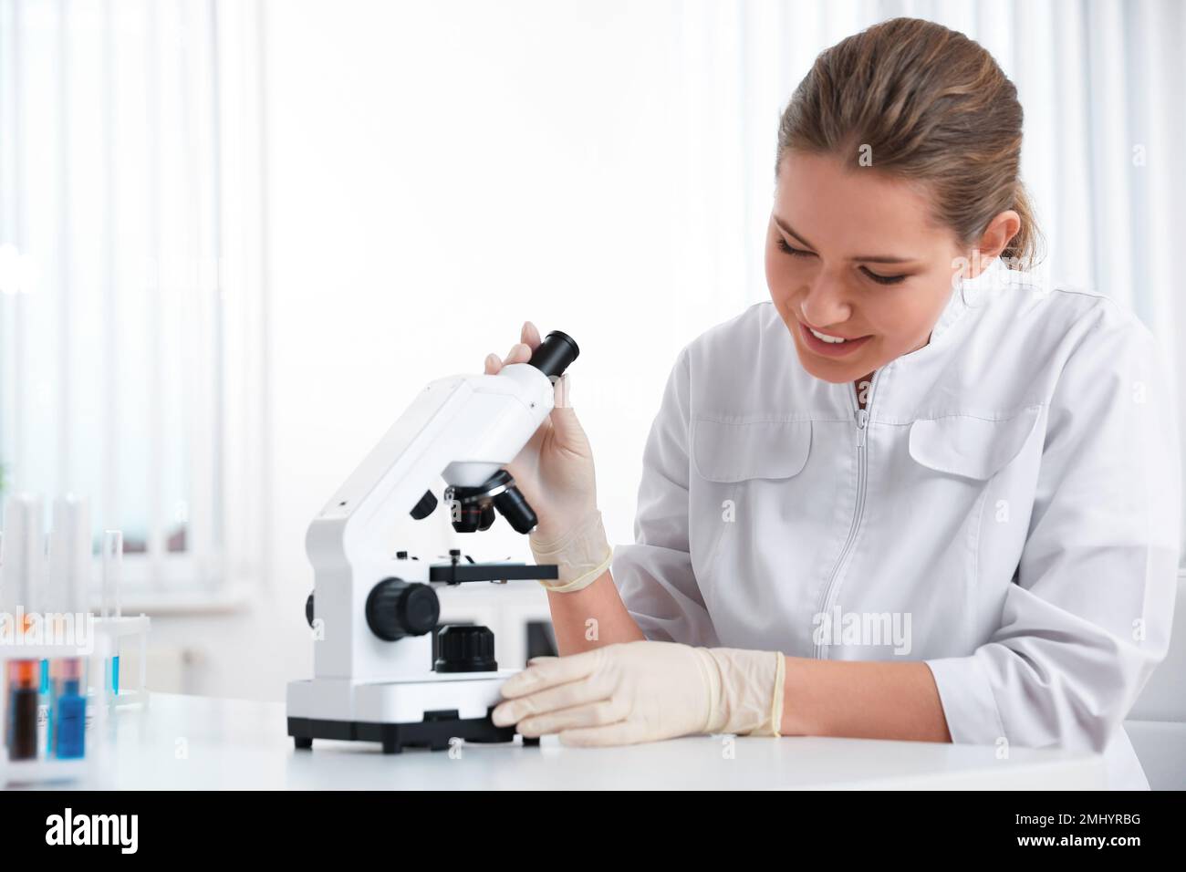 Scientist with modern microscope at table. Medical research Stock Photo ...