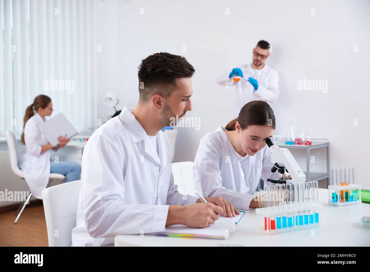 Medical students with microscope in modern laboratory Stock Photo - Alamy