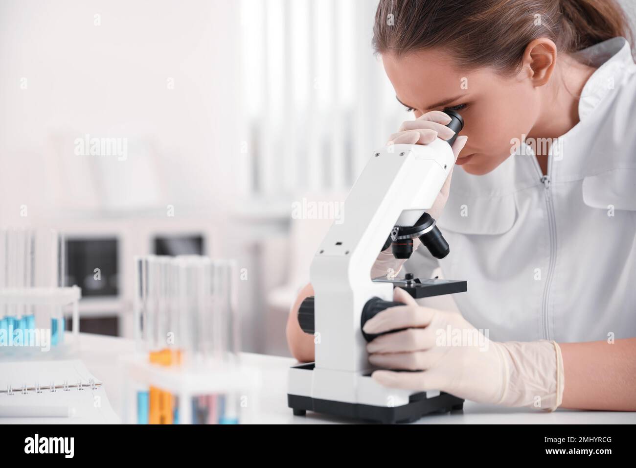 Scientist using modern microscope at table, closeup. Medical research ...