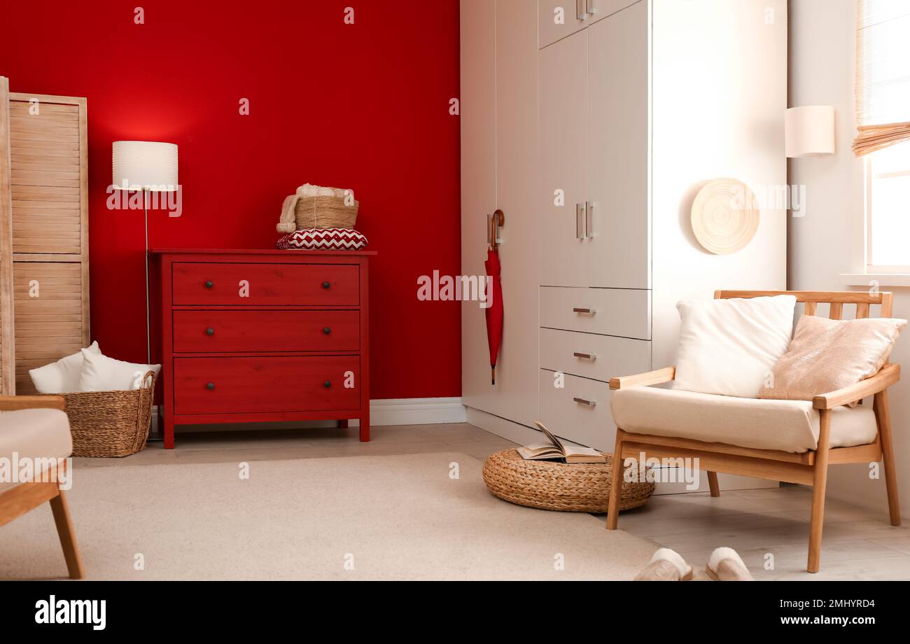 Modern room interior with red chest of drawers Stock Photo - Alamy