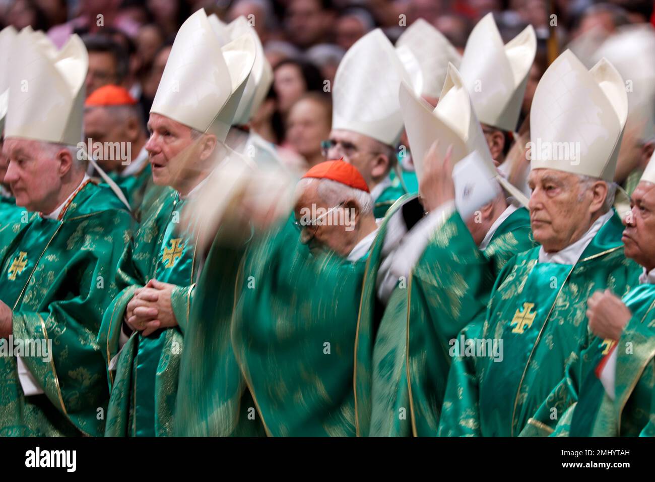 Prelates wear green vestments as they attend an opening Mass for the ...
