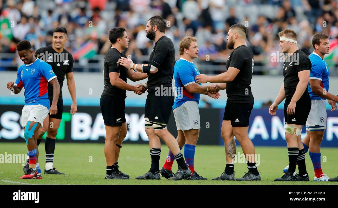 New Zealand and Namibian players shake hands following their Rugby ...
