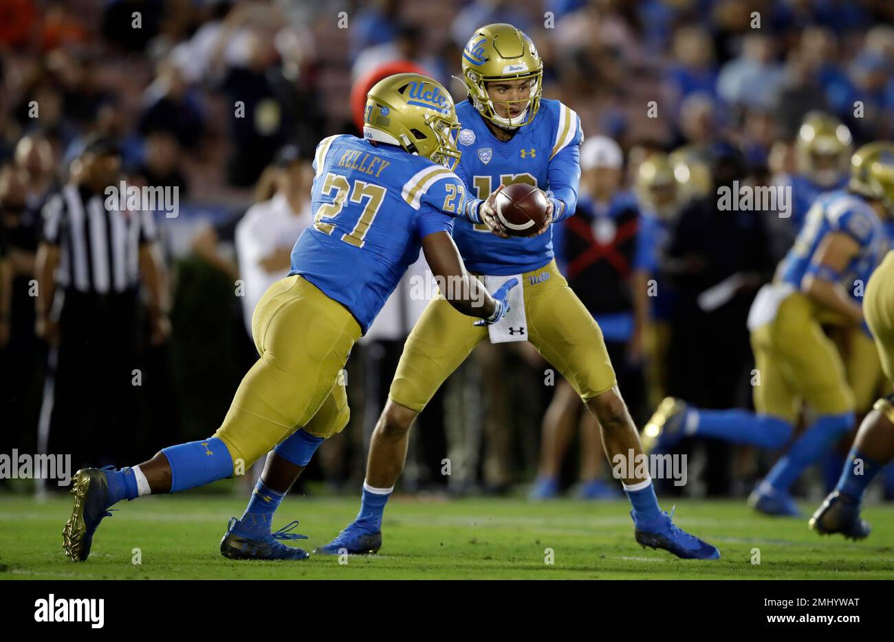 UCLA quarterback Austin Burton (12) hands off to running back Joshua ...