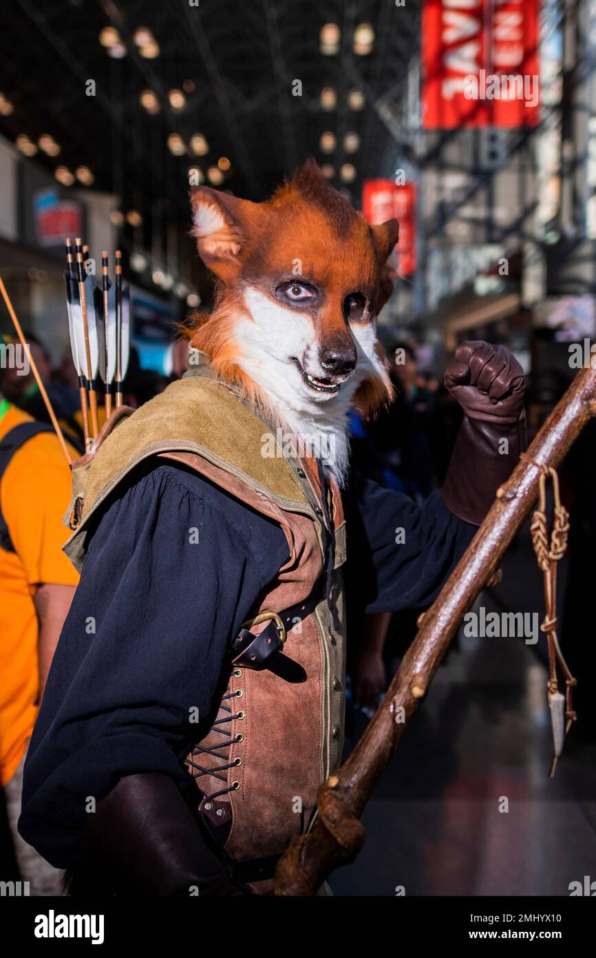 An attendee dressed as Disney's "Robin Hood" poses during New York ...