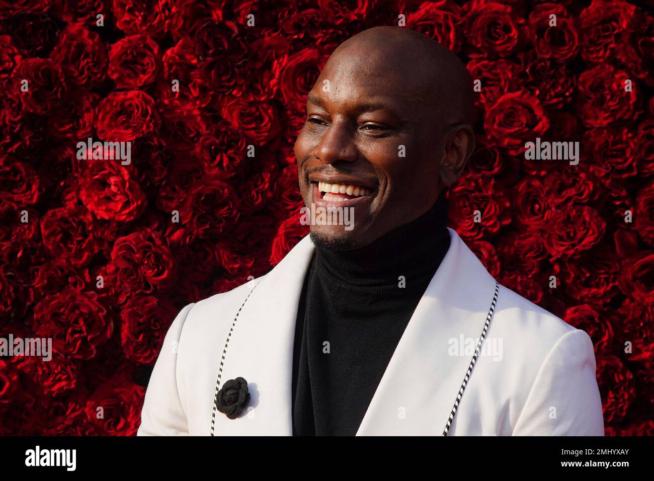 Tyrese Gibson poses for a photo on the red carpet at the grand opening ...