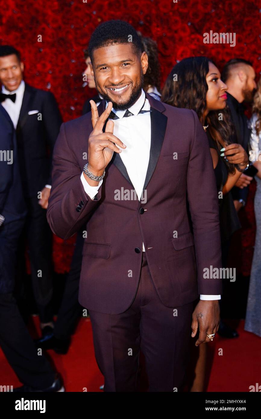 Usher poses for a photo on the red carpet at the grand opening of Tyler ...