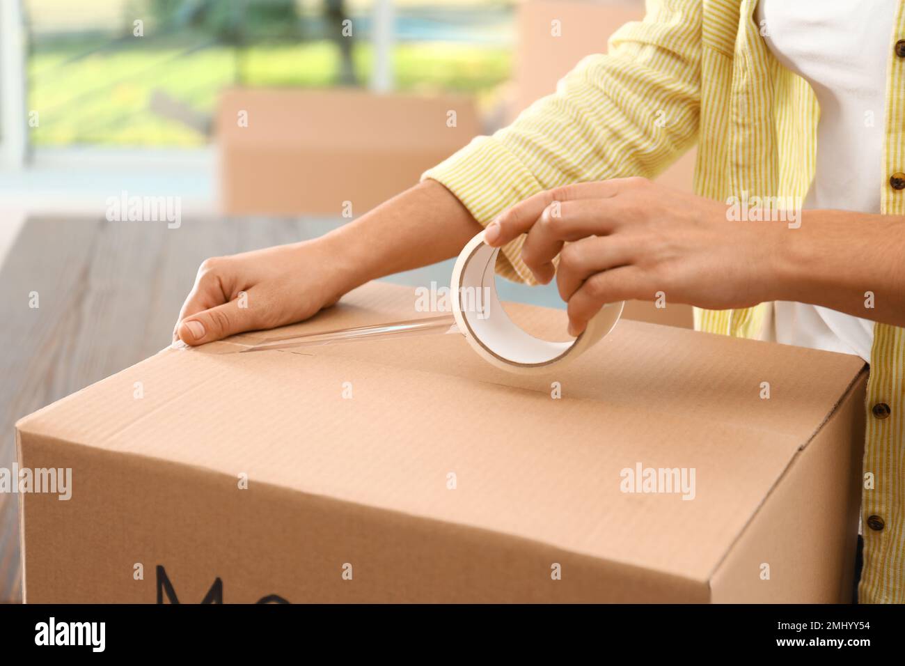 Woman packing box at table, closeup. Moving day Stock Photo - Alamy