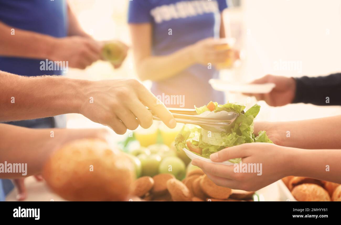 Woman serving food poor hi-res stock photography and images - Alamy