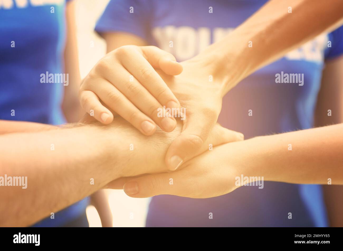 Group students joining hands hi-res stock photography and images - Alamy