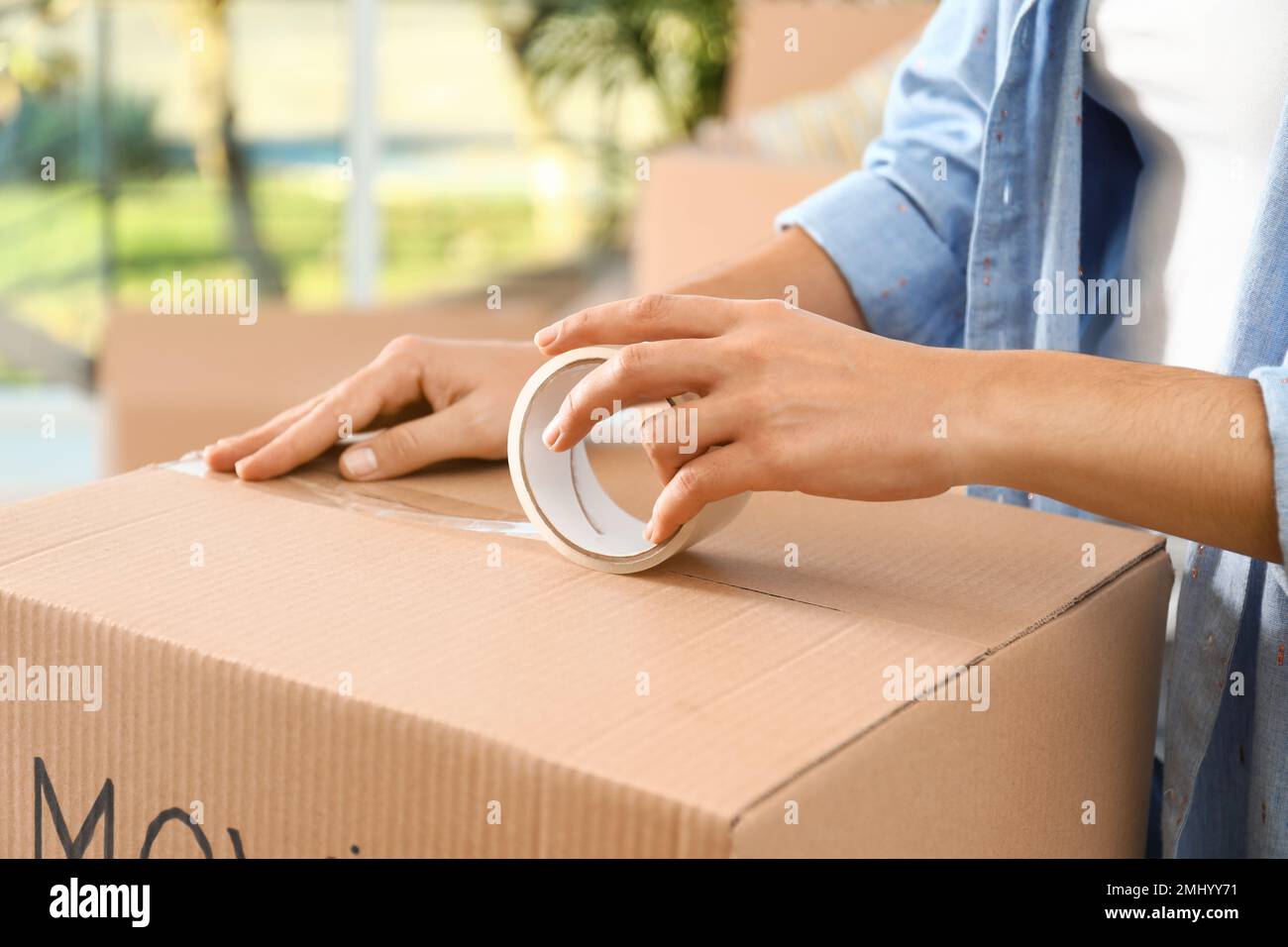 Woman packing box at table, closeup. Moving day Stock Photo - Alamy