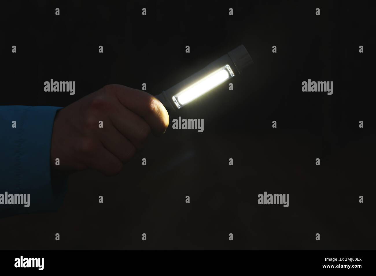 Man holding torch flashlight hi-res stock photography and images - Alamy