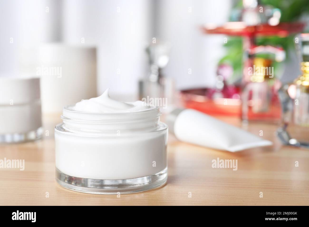Open jar of cream on wooden dressing table. Space for text Stock Photo ...