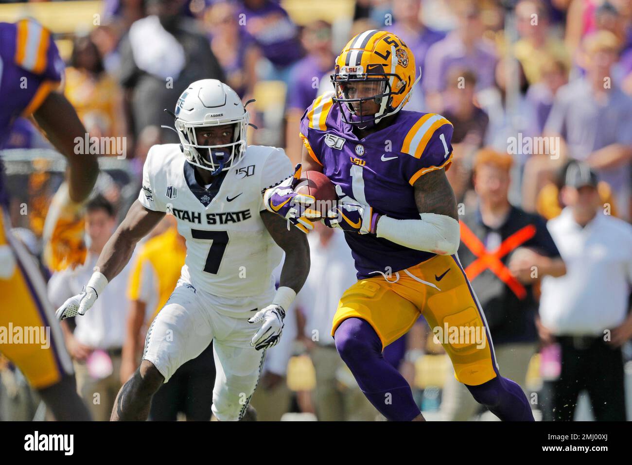 LSU wide receiver Ja'Marr Chase (1) carries past Utah State cornerback ...