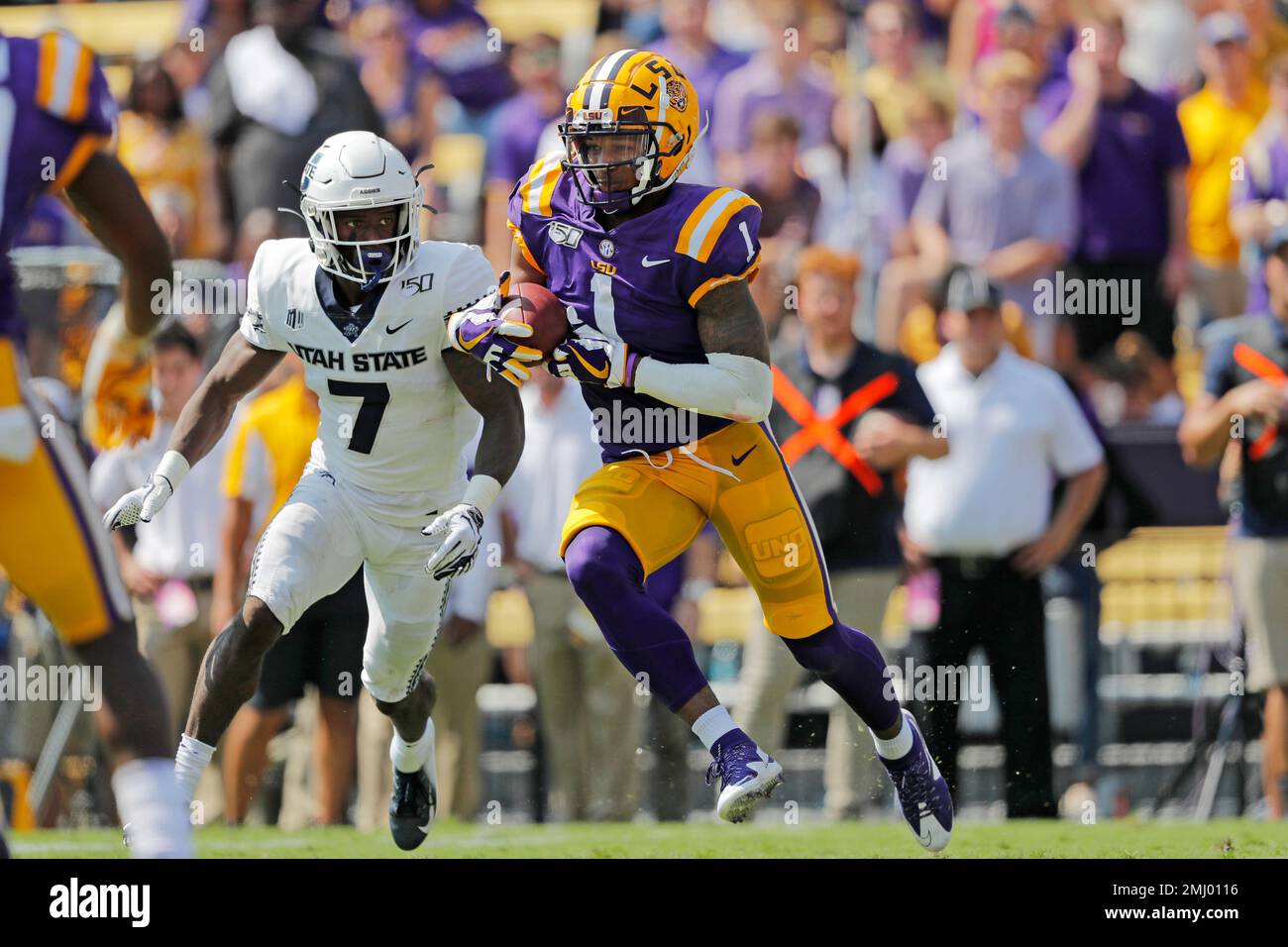 LSU wide receiver Ja'Marr Chase (1) carries past Utah State cornerback ...