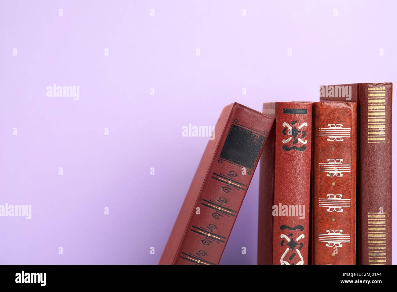 Collection of old books on violet background, space for text Stock ...
