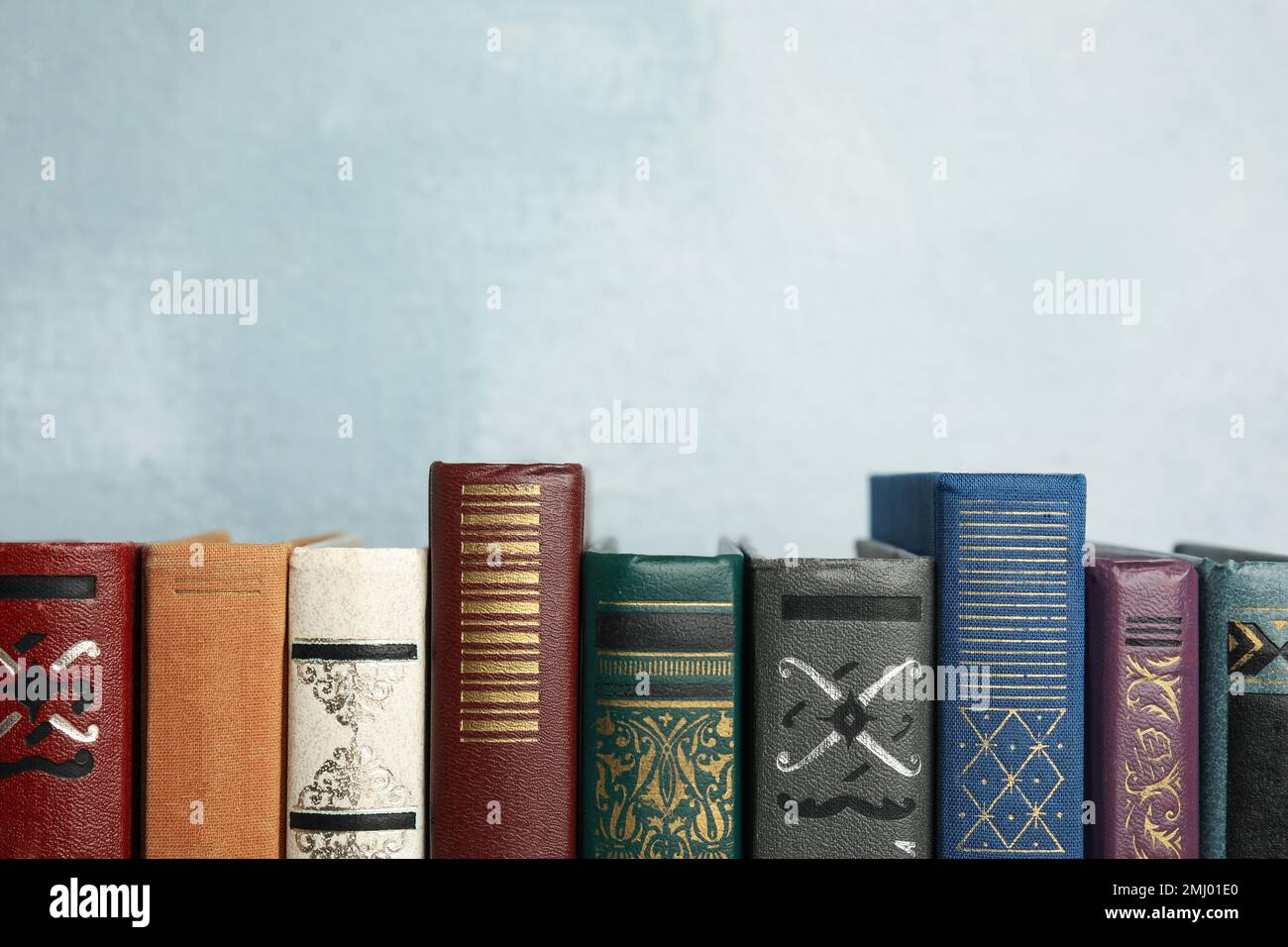 Collection of old books on light blue background. Space for text Stock ...
