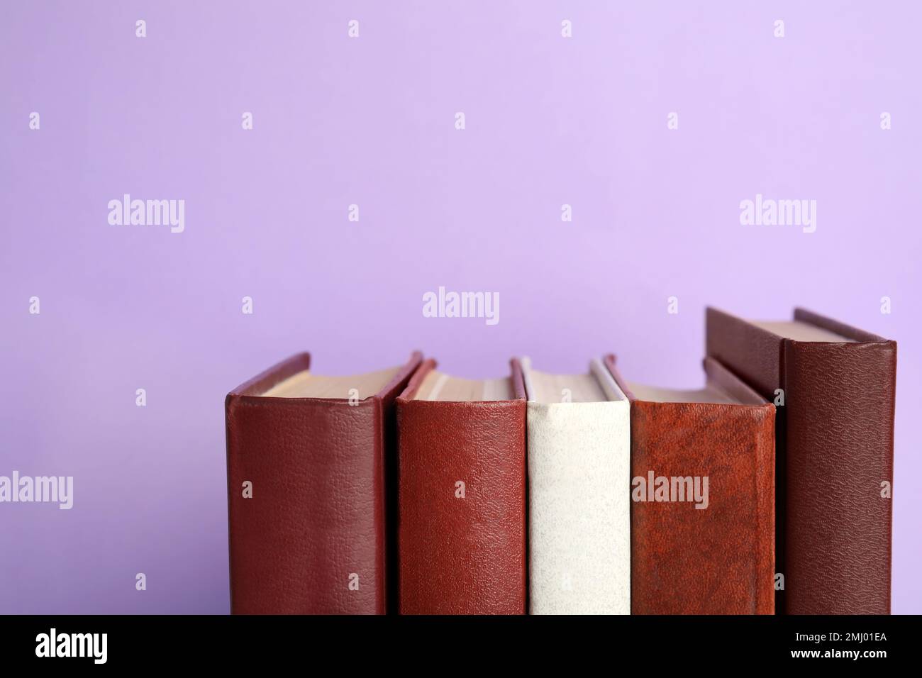 Collection of old books on violet background, space for text Stock ...