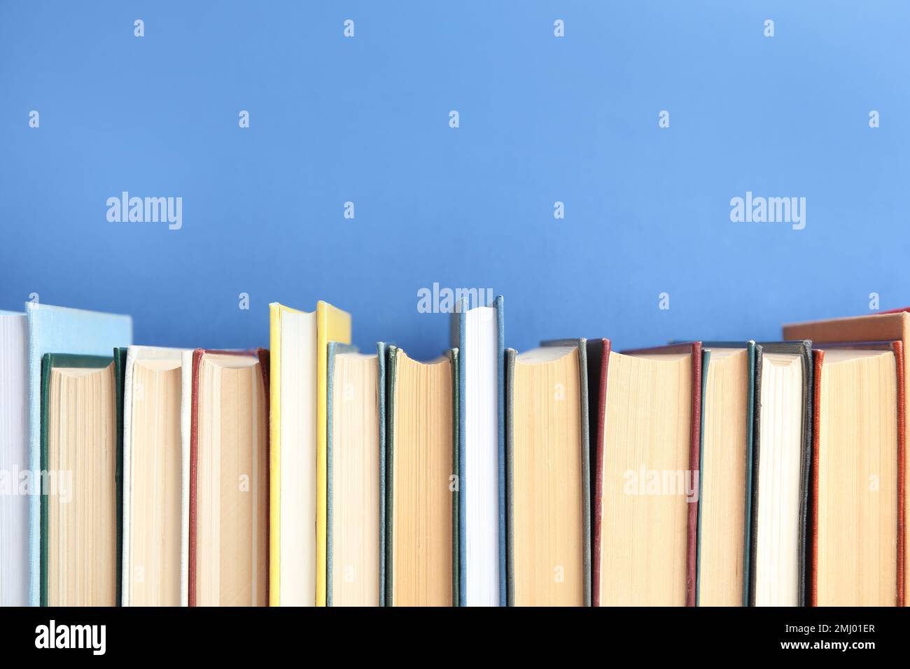 Collection of old books on blue background Stock Photo - Alamy