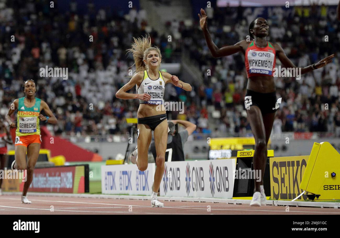 Konstanze Klosterhalfen, of Germany, center, reacts as she takes the ...