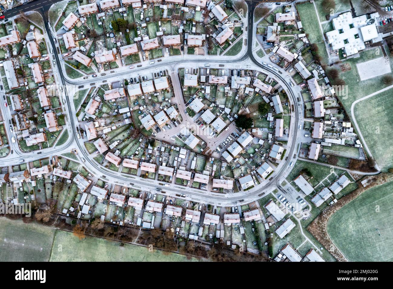 Aerial view directly above the snow covered streets and rooftops of a ...