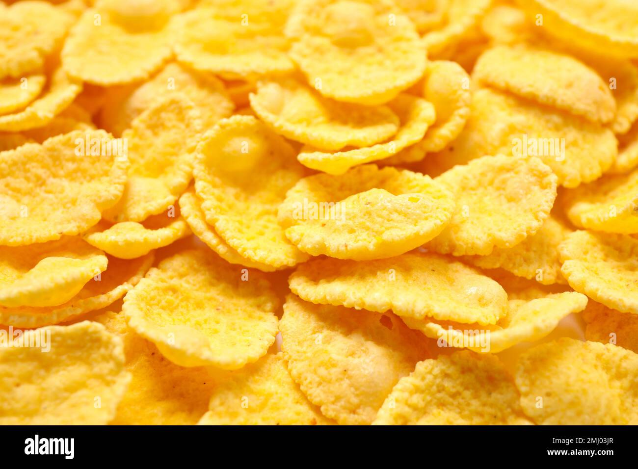 Tasty crispy corn flakes as background, closeup Stock Photo - Alamy