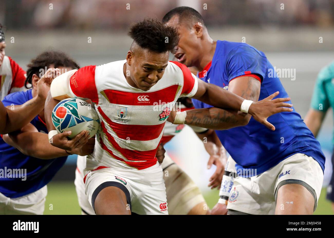 Japan's Kotaro Matsushima runs at that Samoan defense during the Rugby ...