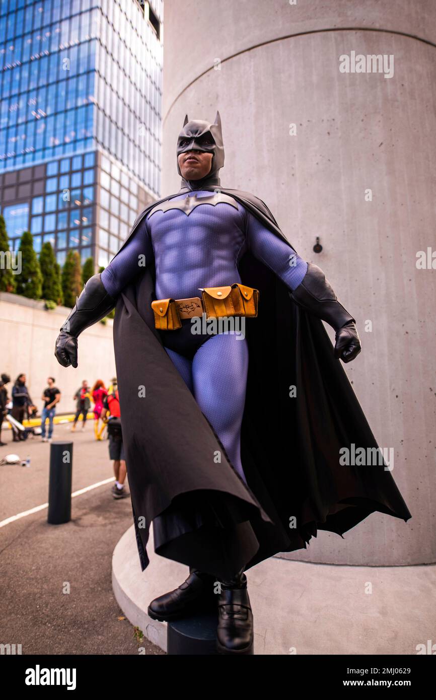 An attendee dressed as Batman poses during New York Comic Con at the ...
