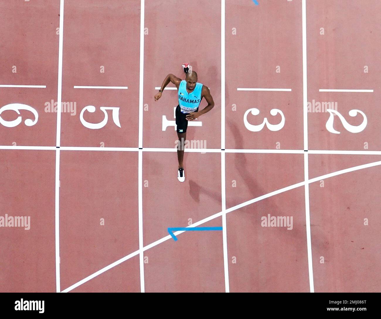 Steven Gardiner, of Bahamas, crosses the finish line to win the men's ...