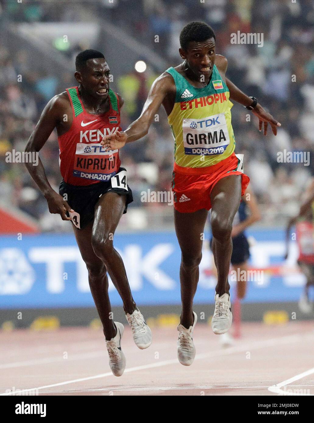 Conseslus Kipruto, of Kenya, left, wins the gold medal ahead of Lamecha ...