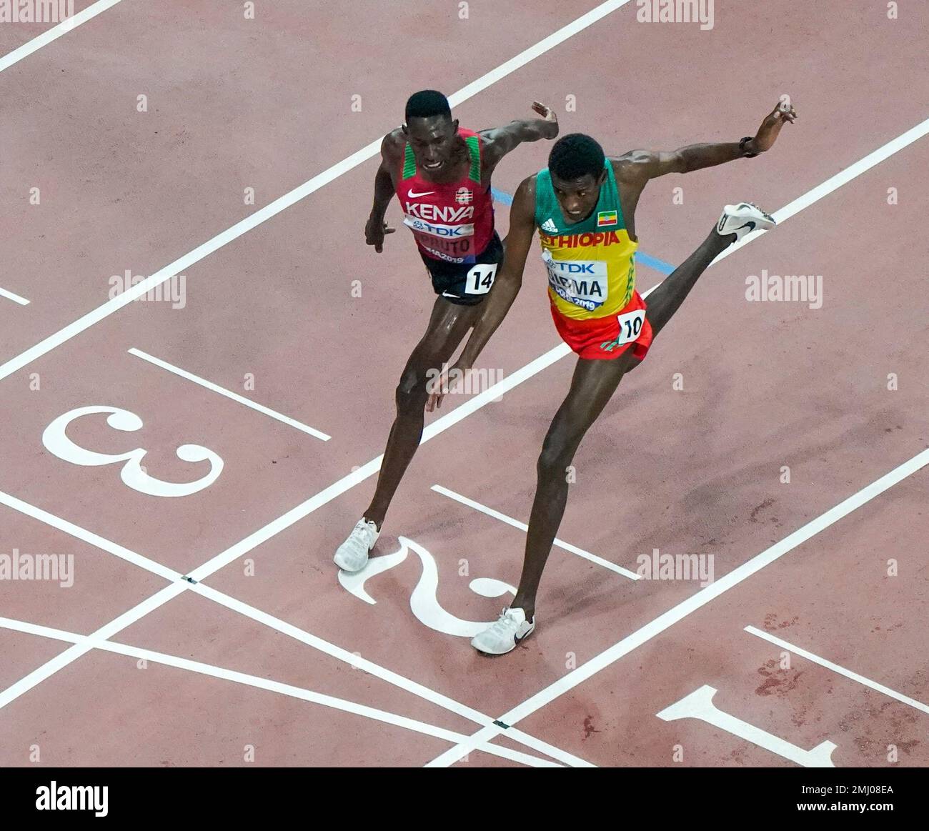 Conseslus Kipruto, of Kenya, and Lamecha Girma, of Ethiopia, cross the ...
