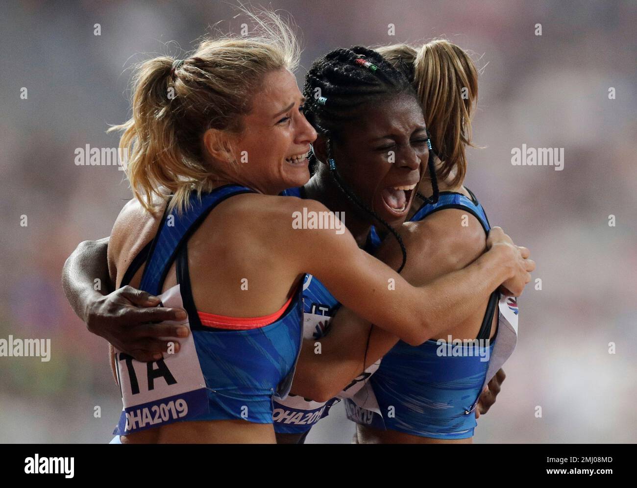 Members of the Italian team celebrate after finishing a women's 4x100 ...