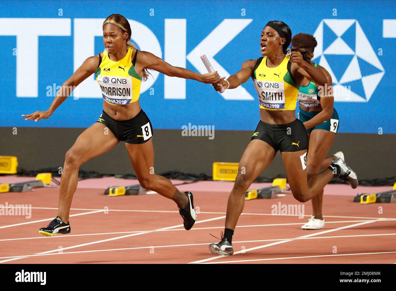 Janelle Smith, right, of Jamaica, hands the baton to Natasha Morrison ...