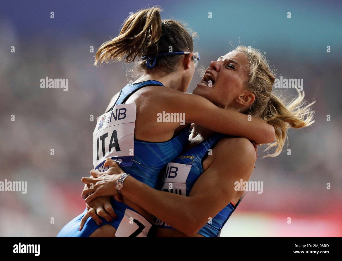 Members of the Italian team celebrate after finishing a women's 4x100 ...
