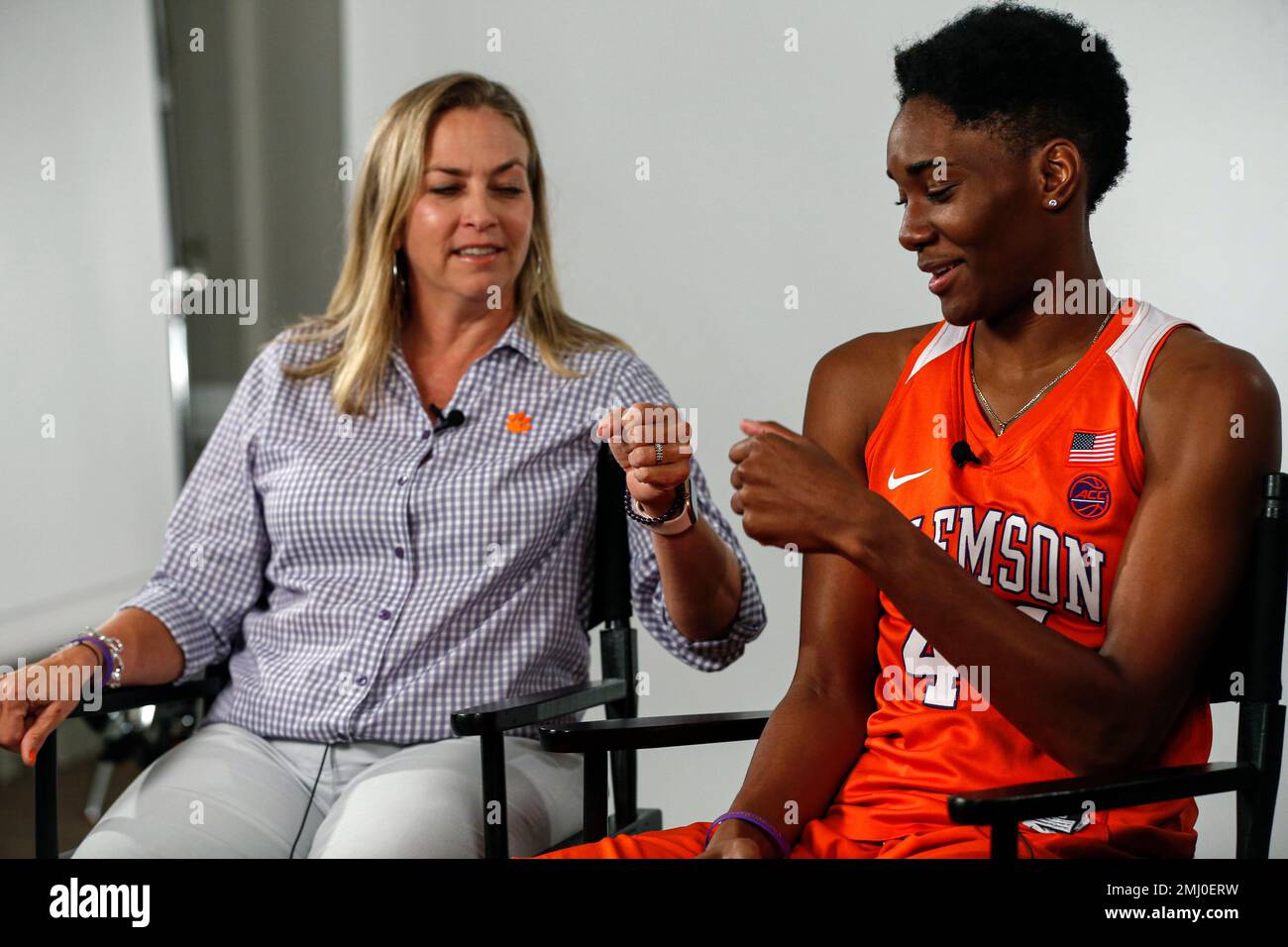 Clemson women's basketball coach Amanda Butler, left, fist bumps Kobi ...