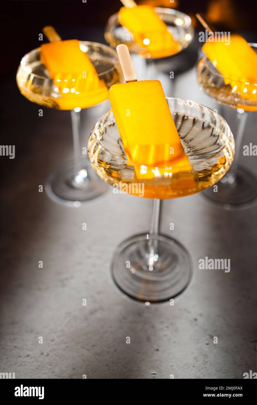 Four glasses of champagne and orange ice cream. Stylish alcohol ...