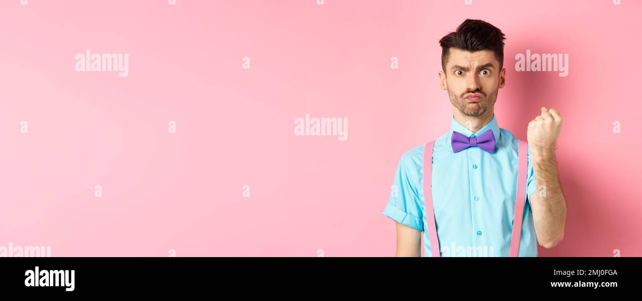 Silly man scolding someone, threaten person with fist, looking grumpy ...