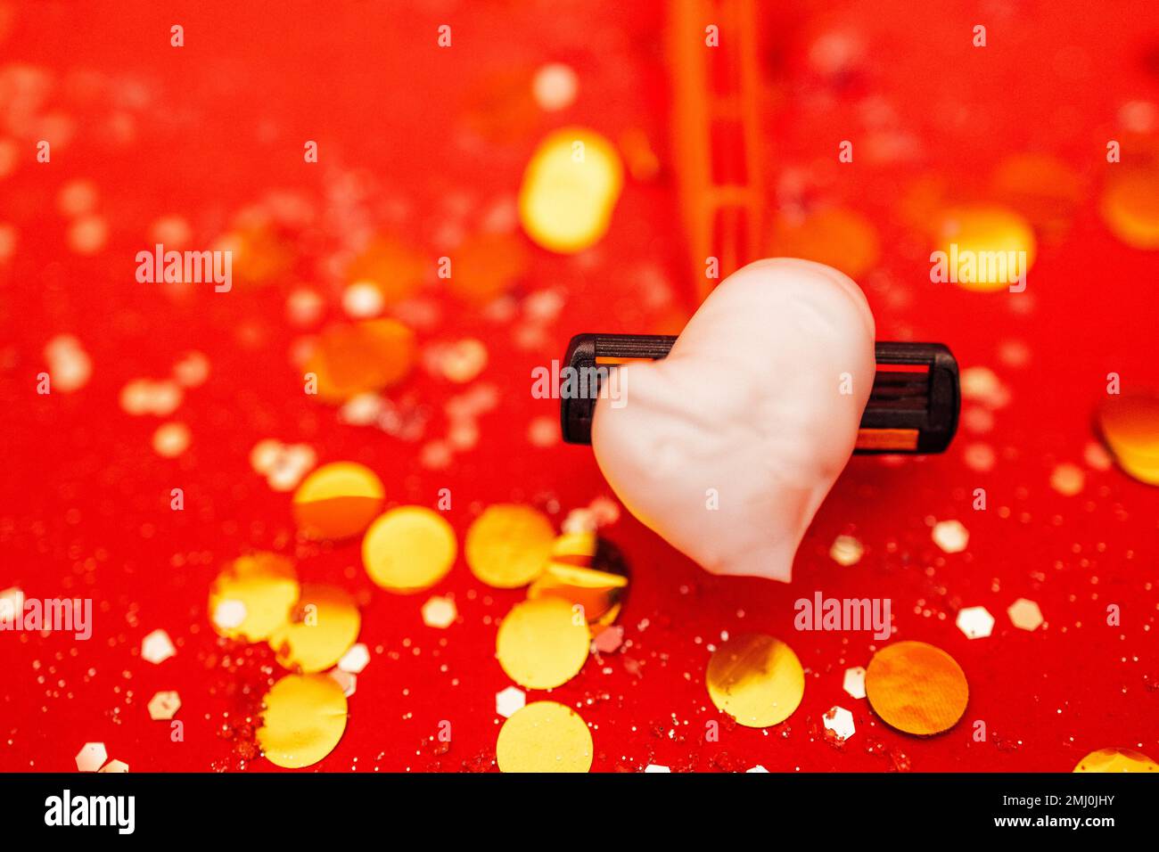 Razor with heart shaped shaving foam. Bright red background with silver ...