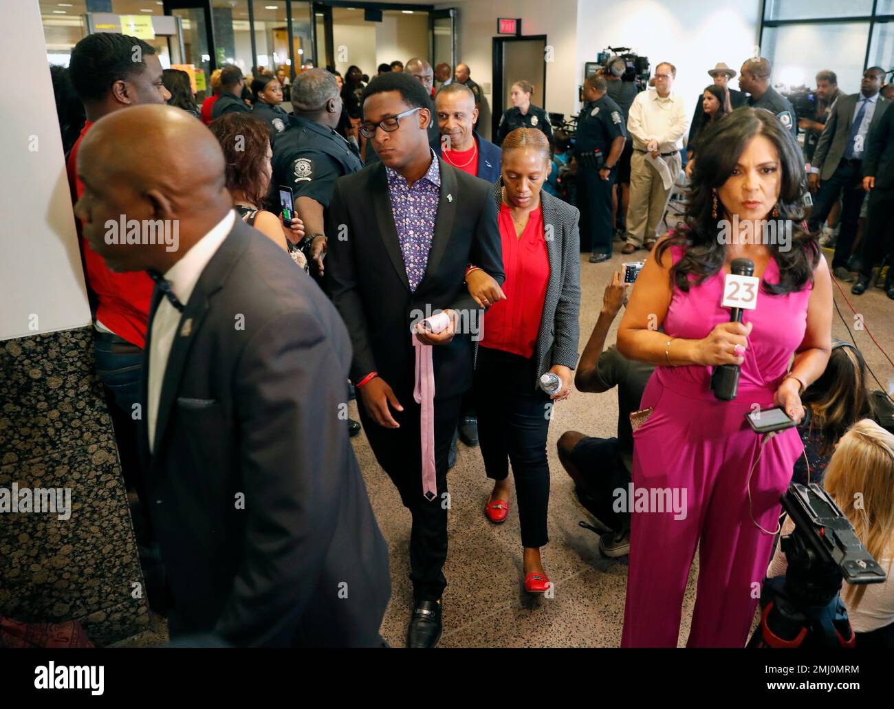Botham Jean's younger brother Brandt Jean, second from left, walks out ...