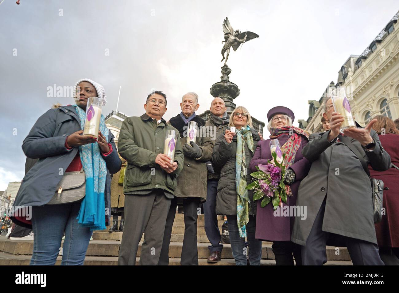 Robert Rinder MBE (centre) with survivors of the Holocaust holding lit ...