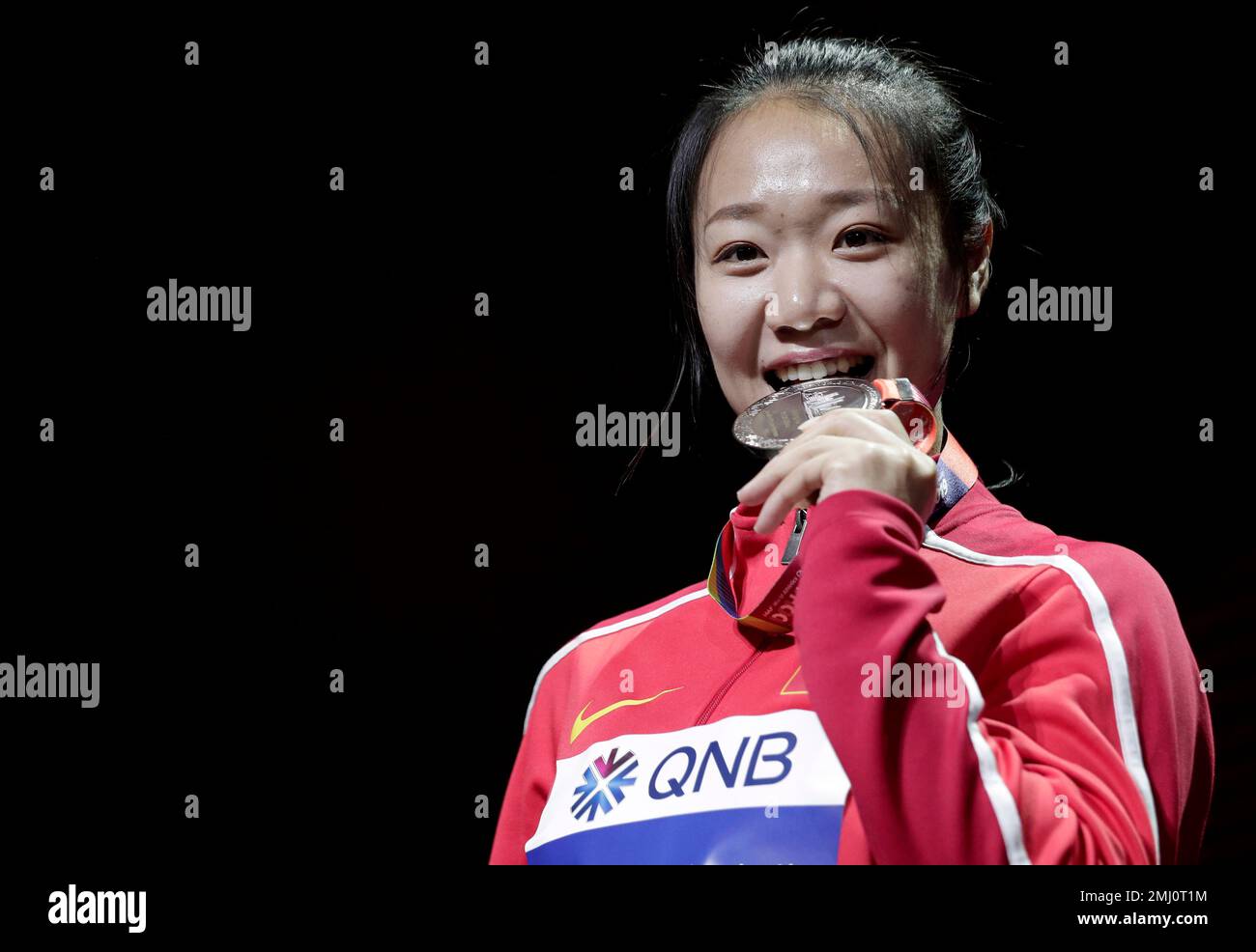 Liu Shiying of China nites her silver medal during the winners ...