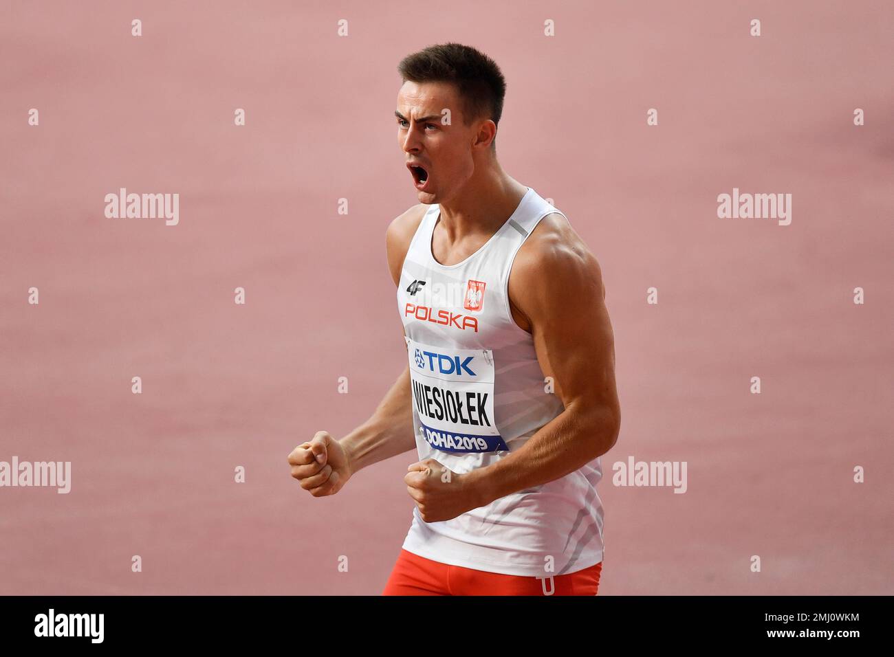 Pawel Wiesiolek, of Poland, celebrates after crossing the finish line ...