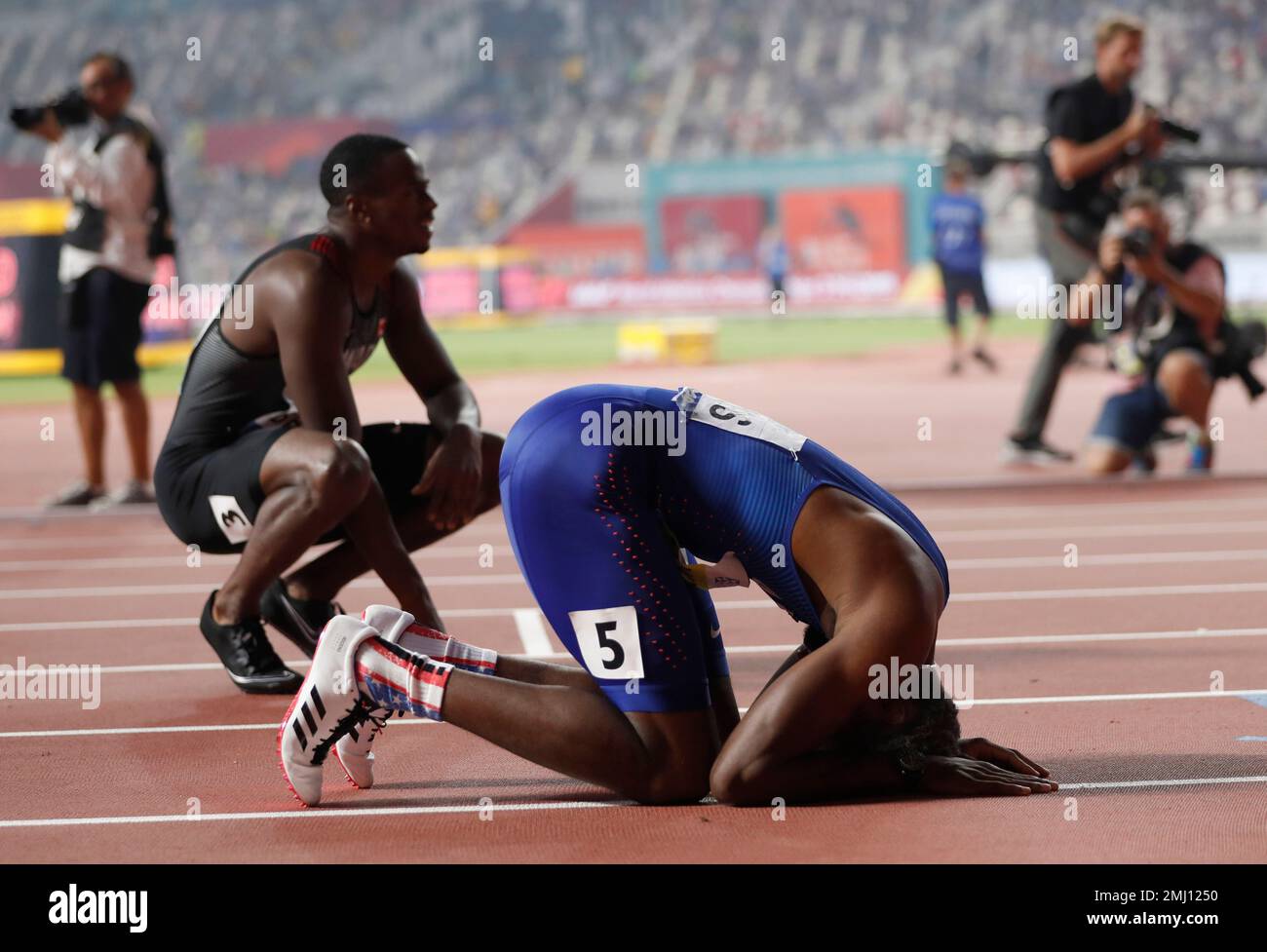 Noah Lyles of the U.S., gold, right, reacts after winning the gold ...