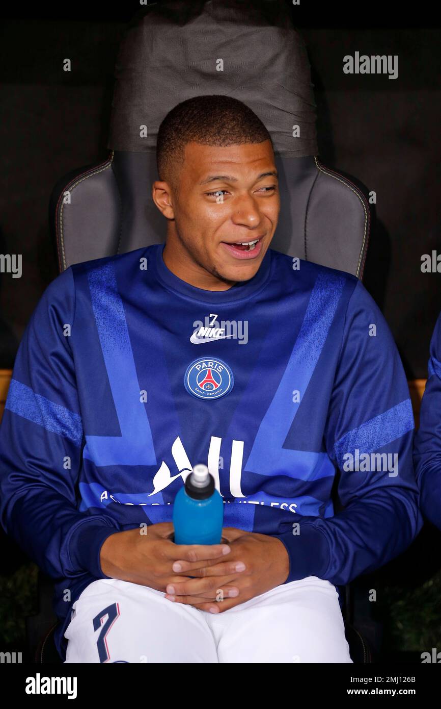 PSG's Kylian Mbappe sits on the bench before the start of the Champions ...