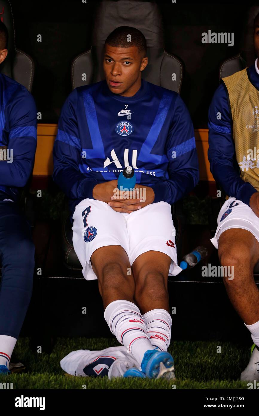 PSG's Kylian Mbappe sits on the bench before the start of the Champions ...