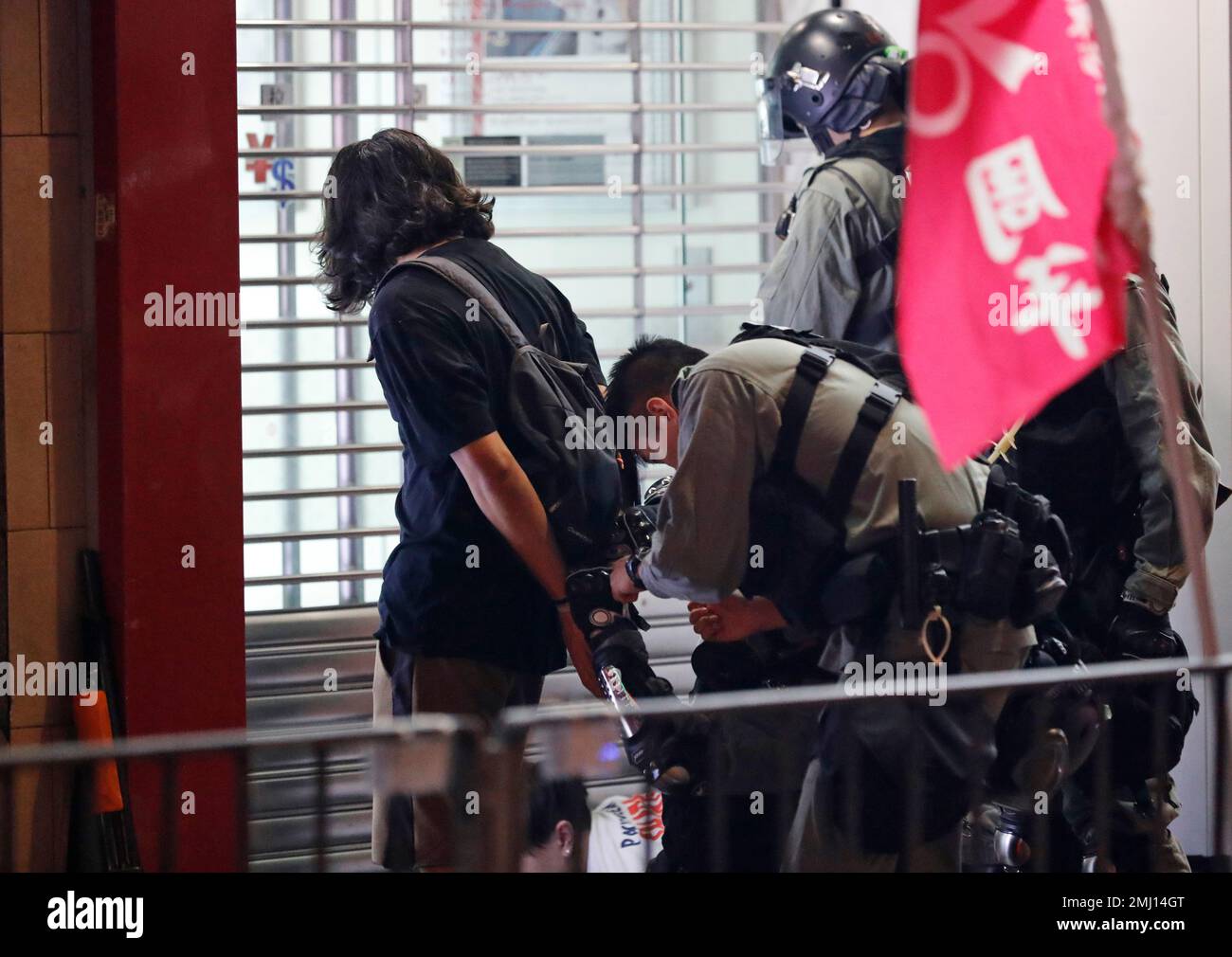 Policemen detain a protestor in Hong Kong, Tuesday, Oct. 1, 2019. Hong ...