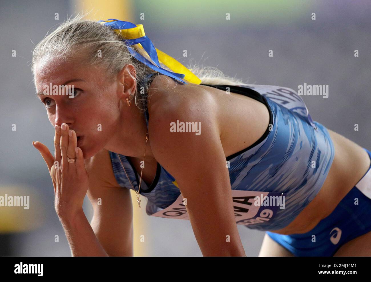 Anna Ryzhykova, of Ukraine blows a kiss after finishing a women's 400 meter hurdle heat at the ...